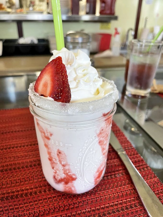 That strawberry shake looks like summer vacation in a mason jar, complete with whipped cream clouds.