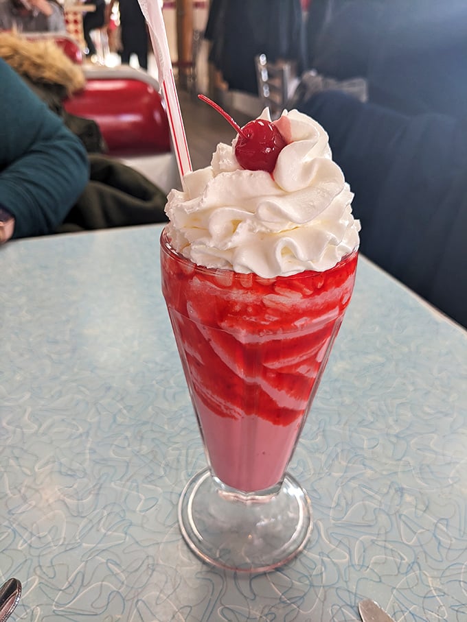 This strawberry milkshake isn't just a drink, it's a dessert skyscraper with a cherry on top that would make the Willis Tower jealous.