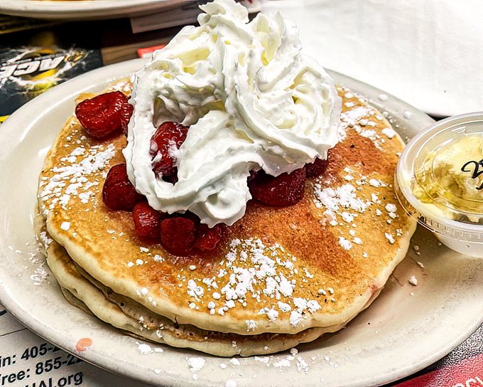 These pancakes aren't just breakfast &ndash; they're dessert with permission. The whipped cream mountain and strawberry valley create a landscape of pure joy.