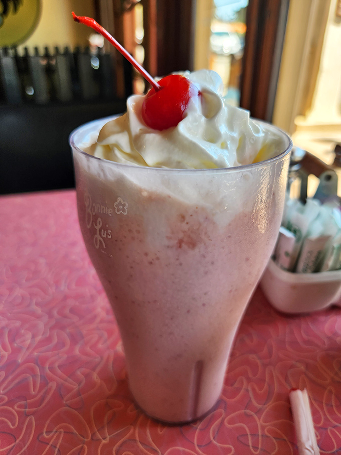 A strawberry shake crowned with whipped cream and a cherry. Childhood nostalgia in a glass, but somehow better than you remember.