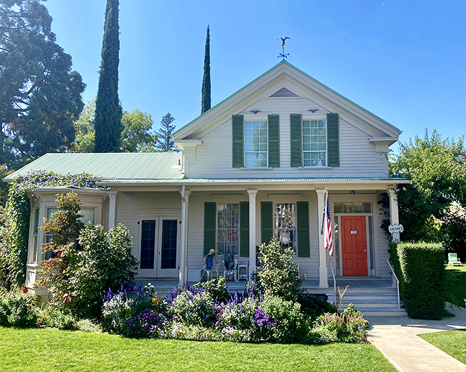 The Sutter Creek Inn's wraparound porch and cottage garden create the kind of postcard-perfect scene that makes you want to cancel your return ticket home.