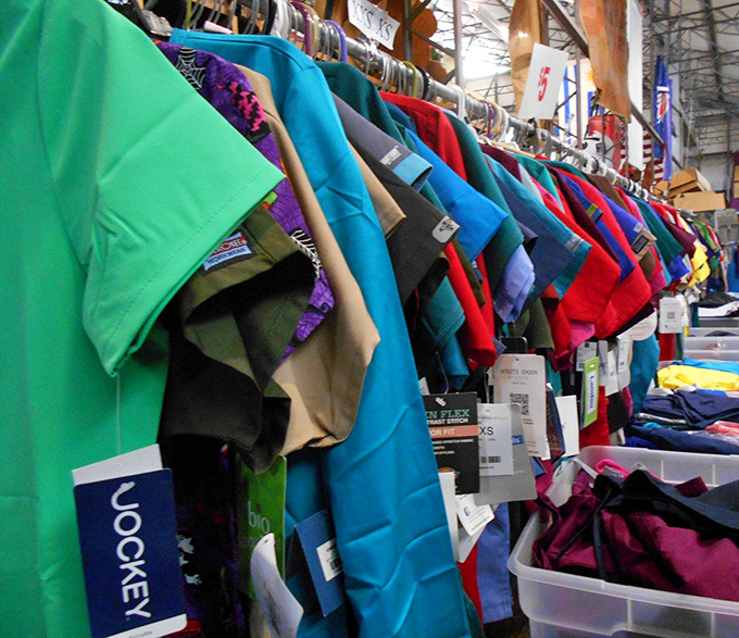 A rainbow of fabrics tells stories of fashion eras gone by, each garment waiting for its renaissance in someone's wardrobe.