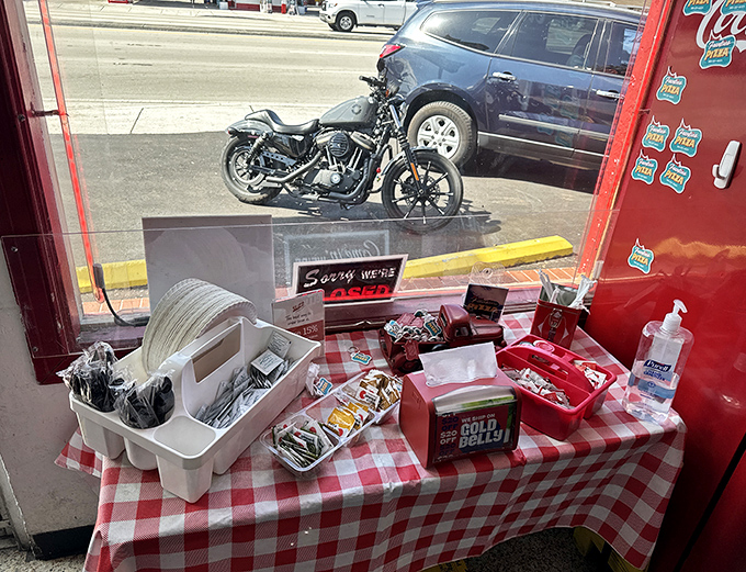 The red-checkered tables hold the essentials &ndash; napkins, parmesan, red pepper flakes &ndash; simple tools for the serious business of pizza enjoyment.
