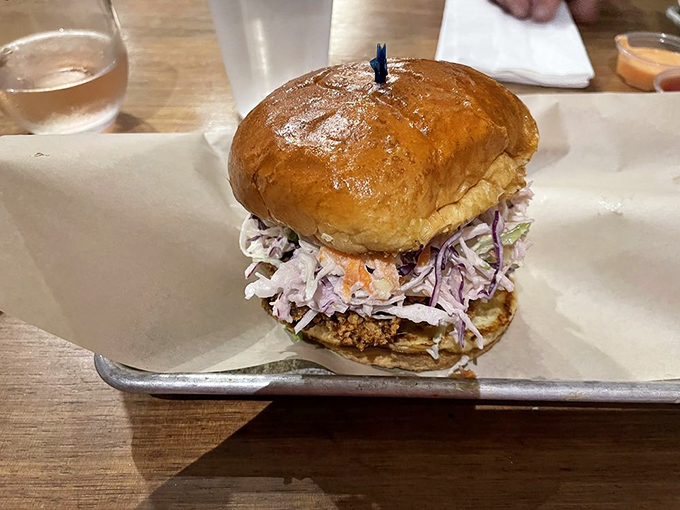 A sandwich that towers with ambition &ndash; crispy cutlet, vibrant slaw, and a bun that somehow manages to hold it all together.