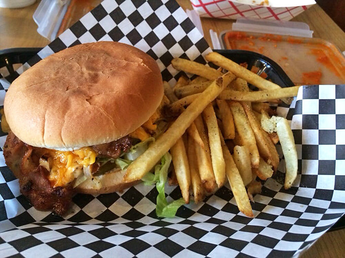 A burger that channels the nostalgic flavors of a classic drive-in, served on a checkerboard paper that's practically Americana in physical form.