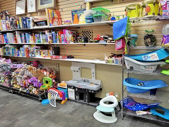 Childhood nostalgia overflows from these shelves. That toy kitchen has probably served more imaginary five-star meals than most real restaurants.