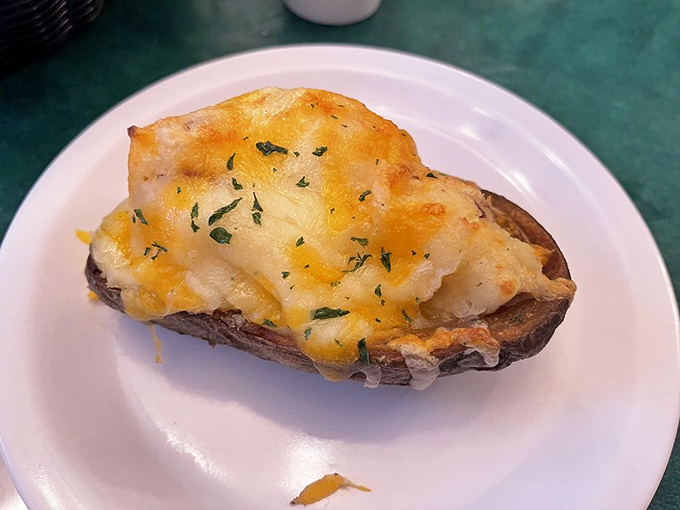 A twice-baked potato that's been promoted to main character status, with cheese melted so perfectly it deserves its own slow-motion entrance music.