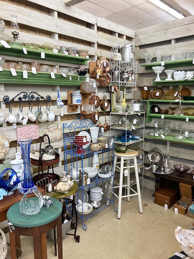 Organized chaos at its finest &ndash; green shelves showcase glassware that survived countless dinner parties only to wait patiently for their next home.
