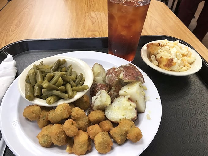 A meat-and-three plate showcasing the vegetable side dishes that often steal the show from their protein companions.