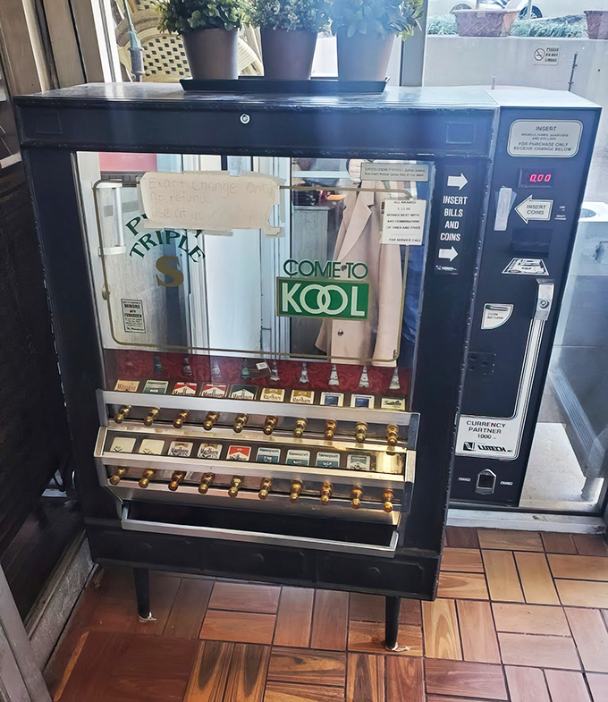 A vintage cigarette machine stands as a quirky time capsule from an era when "smoke after dinner" didn't mean stepping outside.