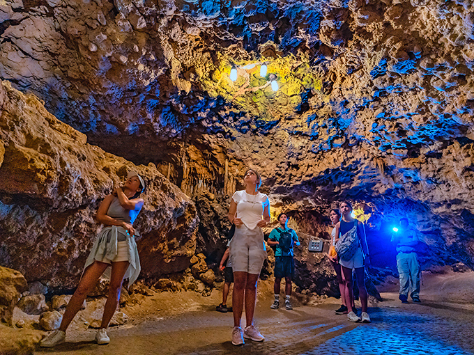 Looking up in awe at nature's cathedral ceiling. Tour guides help visitors appreciate the intricate details of these ancient limestone formations.