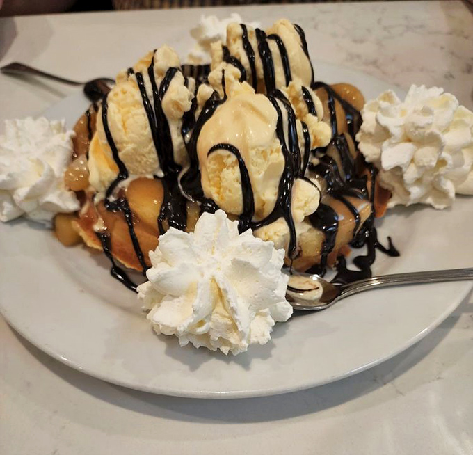 This isn't just a waffle sundae, it's dessert performance art &ndash; where hot fudge and ice cream perform a delicious dance on a golden stage.