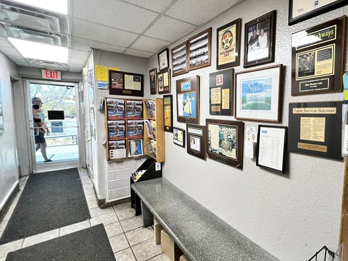The wall of accolades tells a story of decades of excellence. Each frame represents thousands of satisfied customers.