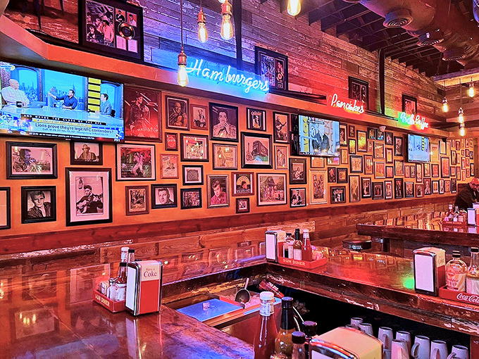 The wall of fame showcases music legends while neon signs glow overhead&mdash;dining under the watchful eyes of rock and country royalty.