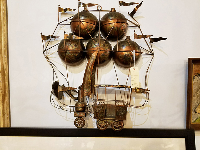 This whimsical metal ship sculpture proves that yesterday's scrap metal is today's conversation-starting wall art.