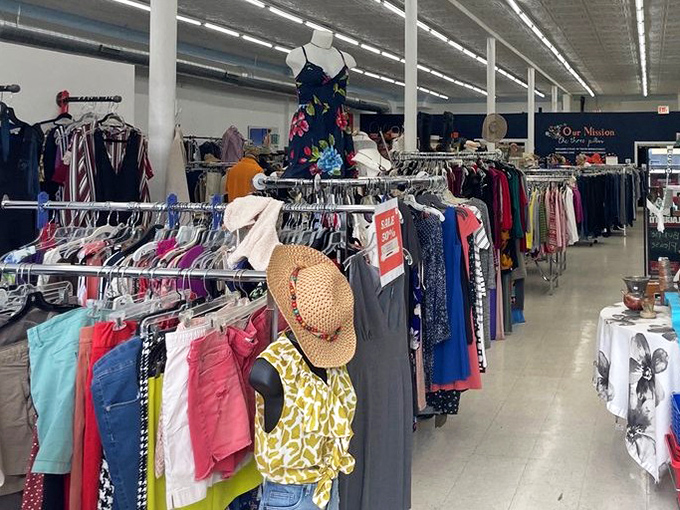 Racks upon racks of possibility! The straw hat adds a touch of summer optimism to this rainbow of secondhand fashion finds.