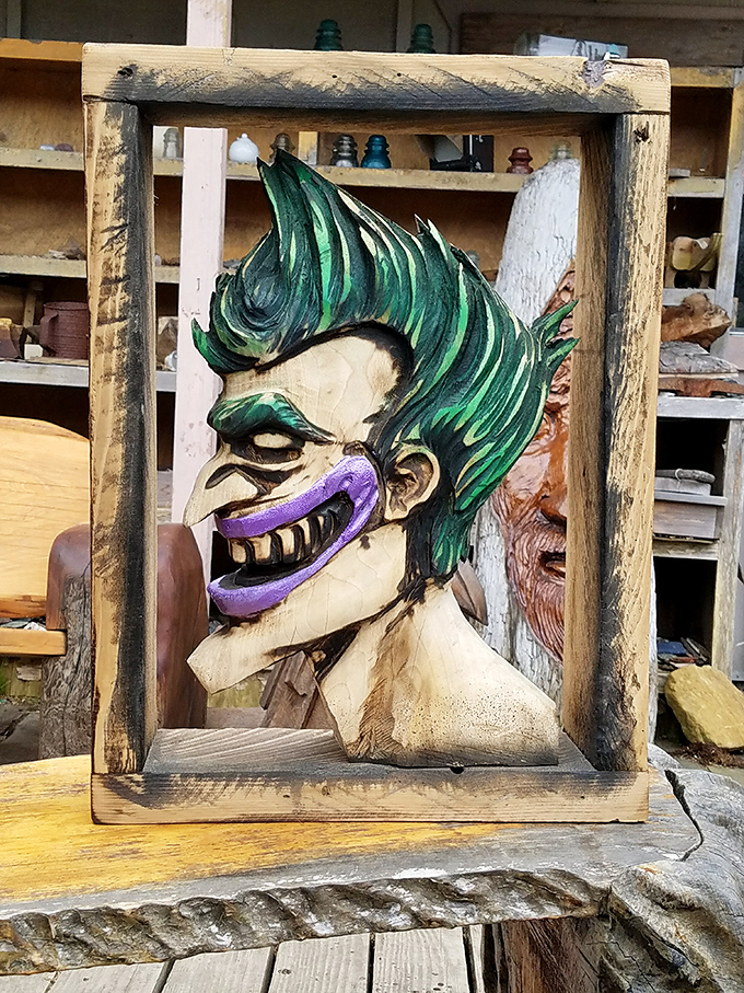 The Joker grins from his wooden frame, asking the eternal question: "Why so serious about conventional art?"