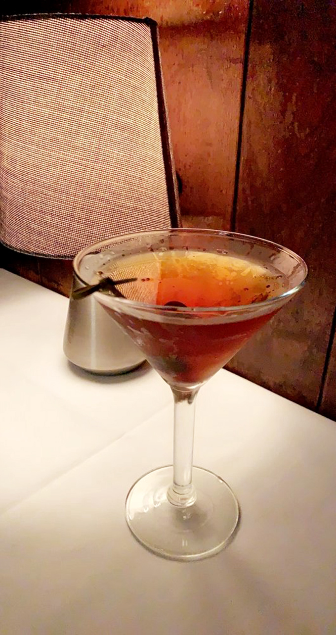 A Manhattan so perfectly balanced it could teach a yoga class, served in the kind of glass that makes you sit up straighter.