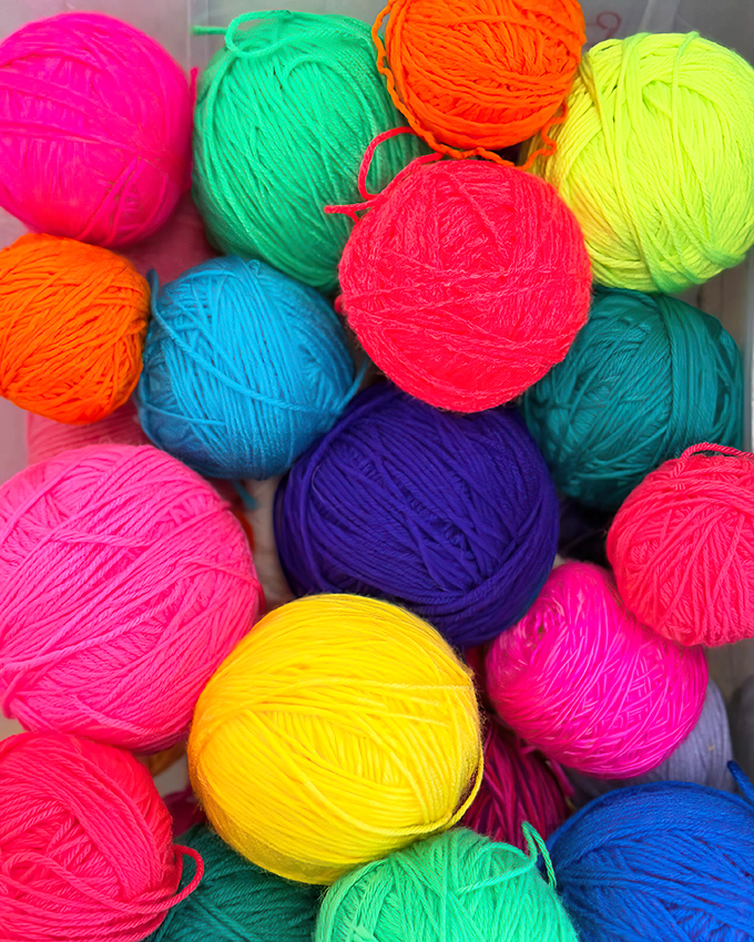 A kaleidoscope of yarn balls promises infinite creative possibilities, from cozy winter scarves to ambitious afghan projects.