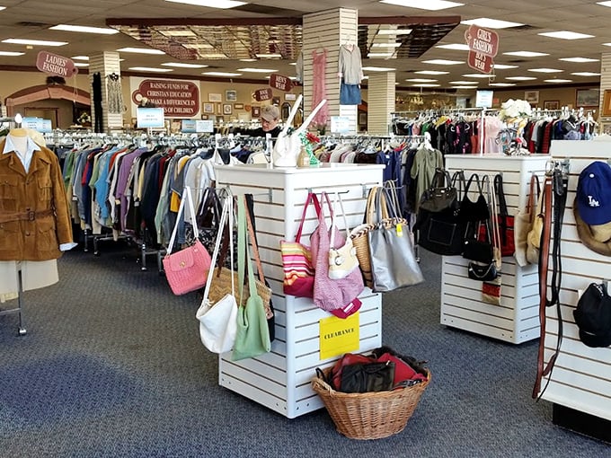 A handbag collector's dream corner where leather totes mingle with canvas carryalls. That cream-colored bag is practically begging to go home with someone.