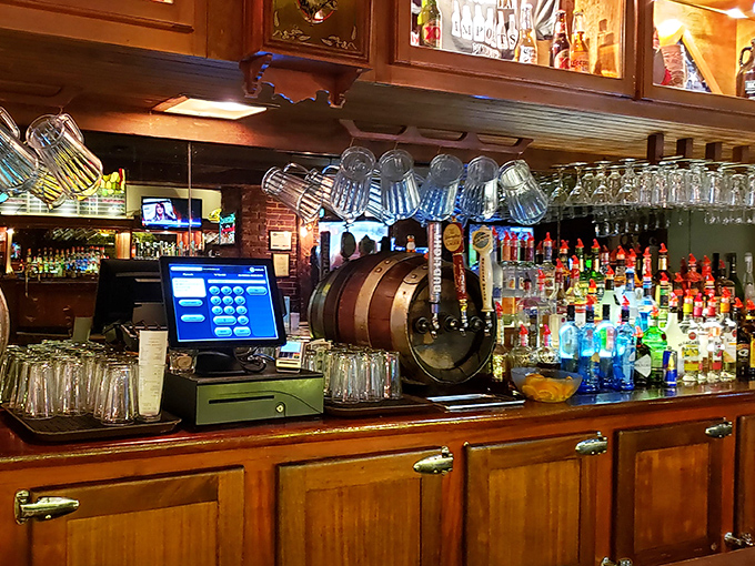 The well-stocked bar showcases an impressive selection of spirits beneath warm pendant lighting and vintage charm.