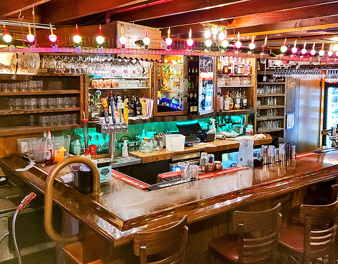 The bar glows like a jewel box of possibilities, where bubble lights meet serious cocktail craftsmanship in perfect harmony.