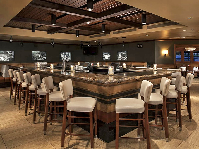 The bar area combines warm wood, cool stone, and comfortable seating&mdash;the trifecta of "I came for one drink but might stay until closing time."