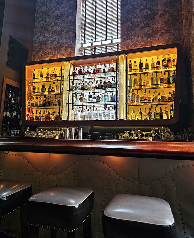The bar's amber glow showcases bottles like museum pieces, suggesting your cocktail isn't just mixed&mdash;it's curated.