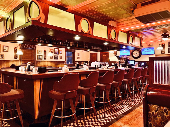 The bar area's warm glow and checkered floor create that perfect "Cheers" vibe where everybody might not know your name yet, but they soon will.