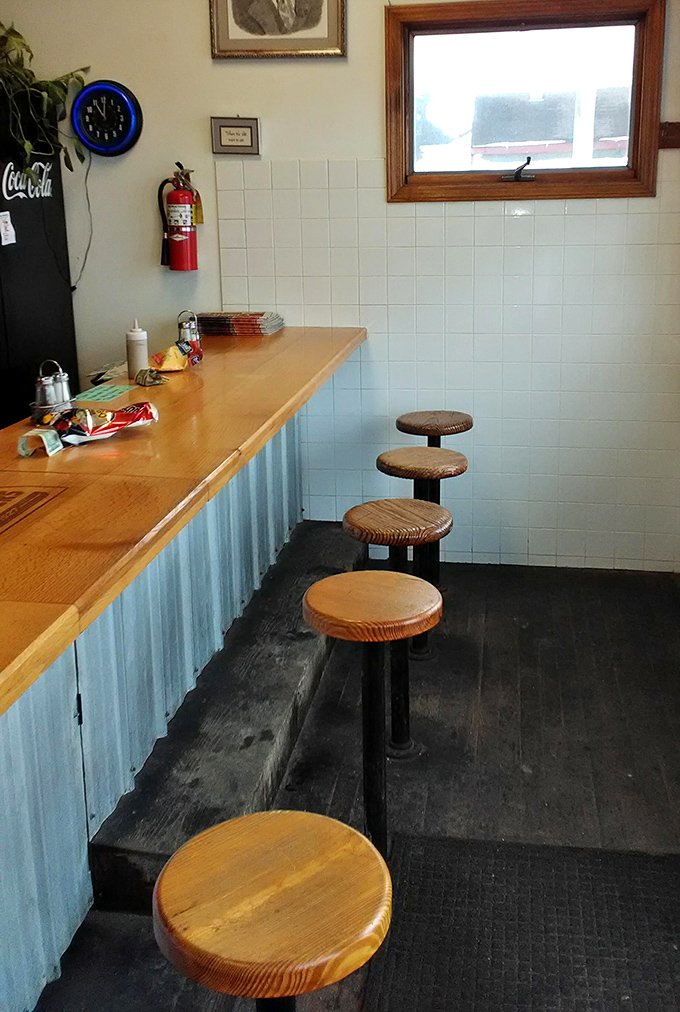 Wooden stools await at the counter, where generations have perched to witness the ballet of burger-flipping firsthand.