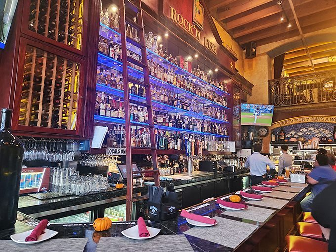 A backlit bar that would make a Broadway stage designer jealous. Those bottles aren't just spirits&mdash;they're the supporting cast in your dining adventure.