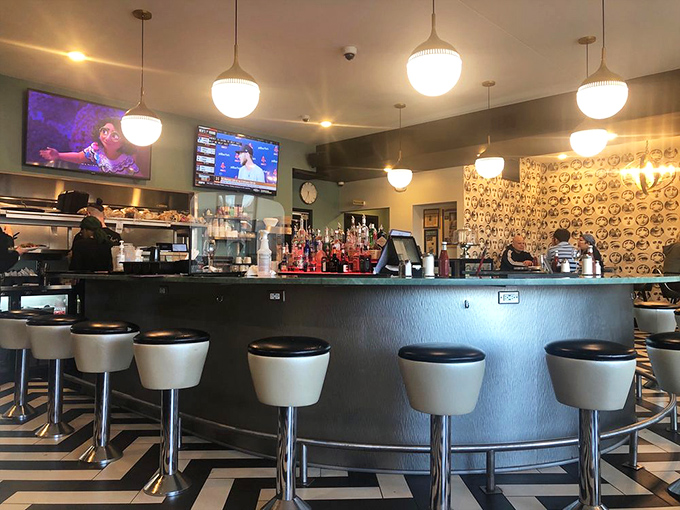 The curved bar invites solo diners and friendly conversation. Those white bar stools have witnessed more Cleveland sports debates than any therapist in town.