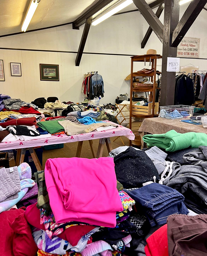 Bargain clothes spread across tables like a fabric buffet where every bite costs less than lunch.