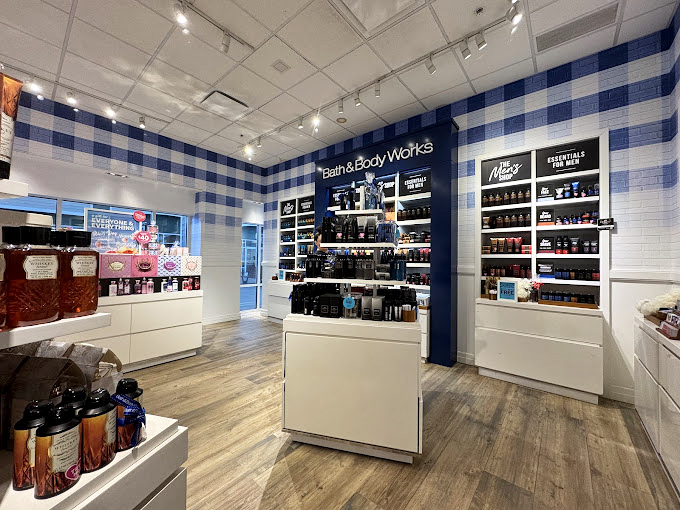 Bath & Body Works' blue gingham walls create a sensory overload zone where one spritz of fragrance can transport you from outlet mall to imaginary beach vacation.