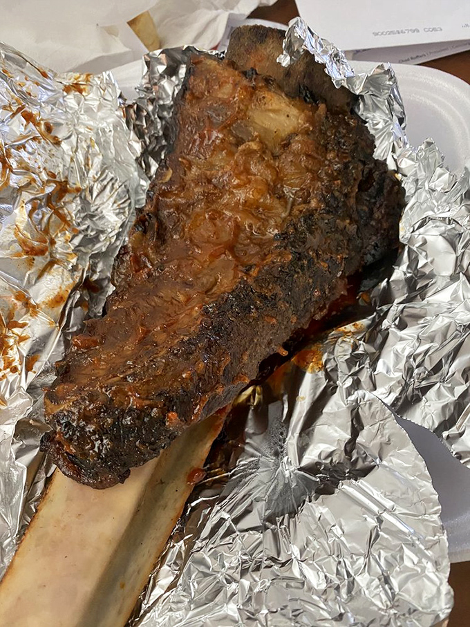 This isn't just a beef rib; it's a prehistoric-looking monument to the art of patience and proper smoking technique.