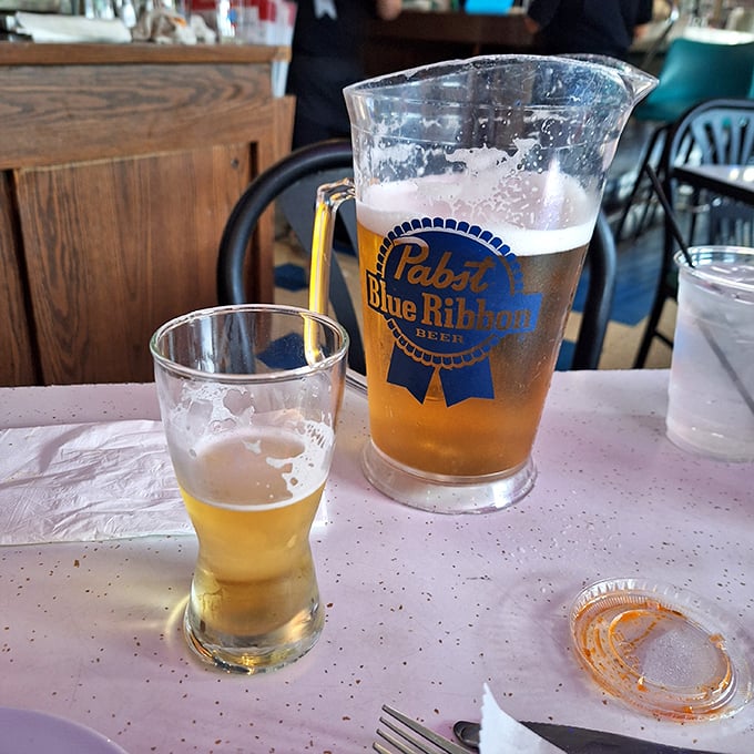 A pitcher of PBR – because sometimes the perfect beverage pairing isn't fancy, it's familiar. Beer and pizza, the original power couple.