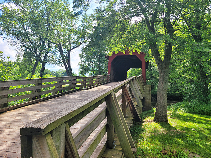 Sunlight dapples through the trees, creating a natural spotlight for this historic structure that refuses to be upstaged.