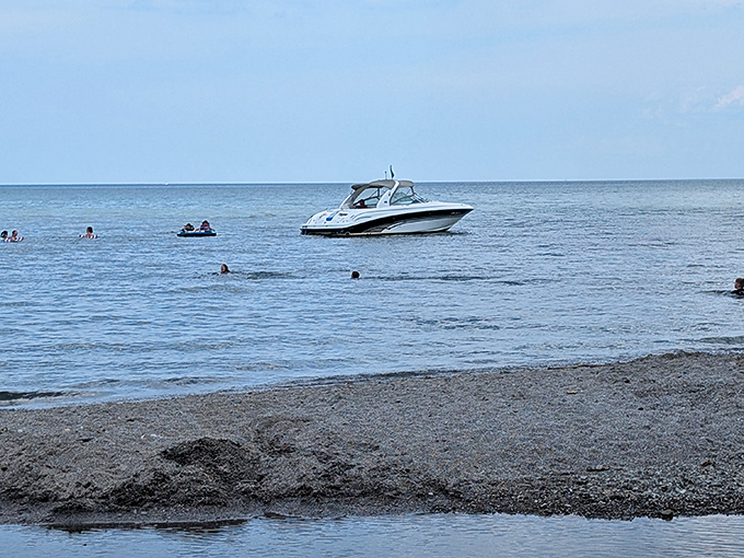 Boaters anchor just offshore, creating that perfect summer tableau of "yes, we're definitely living our best lake life right now."