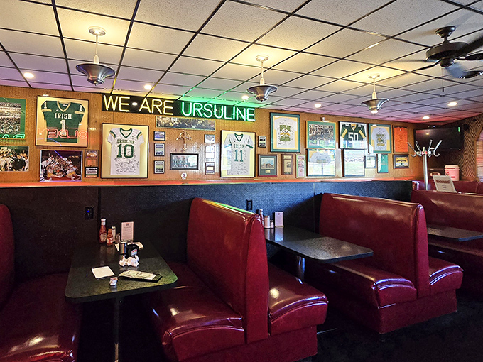 "WE ARE URSULINE" proclaims the wall, but these booths are saying "you are home." Local sports memorabilia tells stories that ESPN never could.