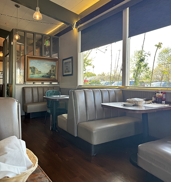 Cozy booths bathed in natural light create the perfect setting for lingering conversations and making important life decisions like "pancakes or waffles?"