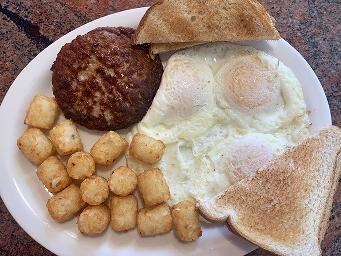 A breakfast platter that means business&mdash;eggs, sausage patty, and those famous Twig Taters forming a holy trinity of morning satisfaction.