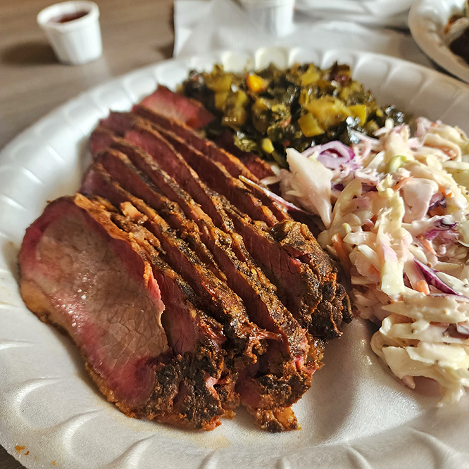 Slices of brisket with that telltale pink smoke ring &ndash; the barbecue equivalent of a gold medal. Paired with coleslaw and vegetables for a perfect plate.