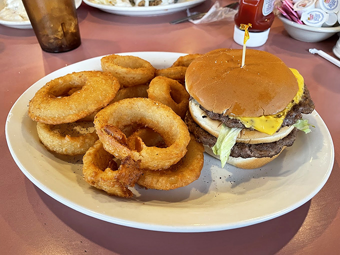 A burger that doesn't need fancy aioli or artisanal buns to impress&mdash;just honest ingredients and onion rings that deserve their own fan club.