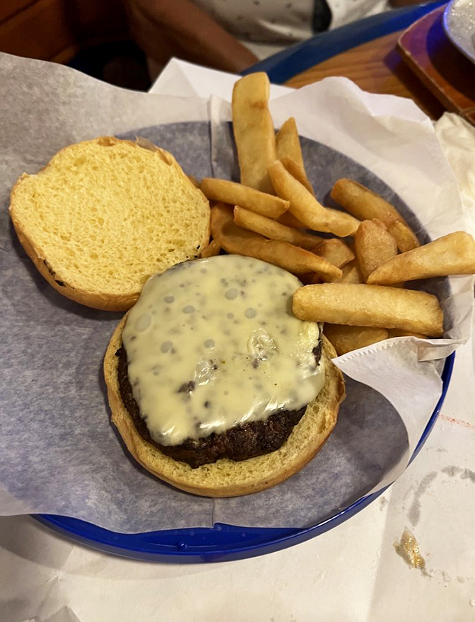 Sometimes even seafood lovers need a burger break. This cheese-draped beauty with golden fries proves they don't just excel at things with fins.