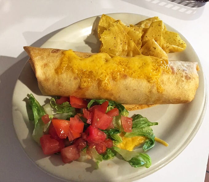 This burrito brings the sunshine with melted cheese, fresh salsa, and enough fillings to require an engineering degree to eat without spillage.
