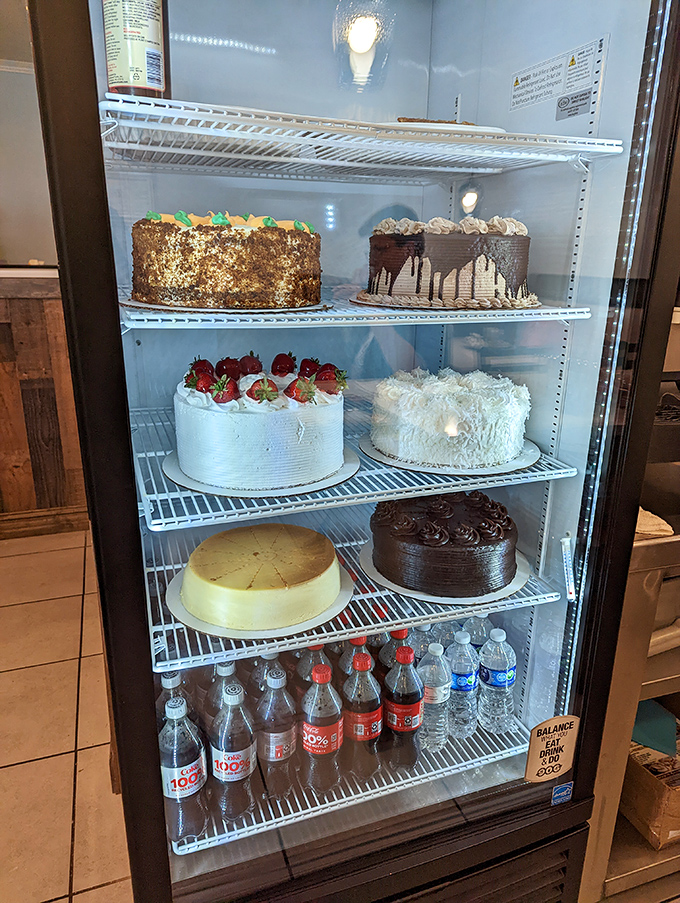 The dessert case: where willpower goes to die and happiness begins. Those cakes aren't just desserts&mdash;they're life achievements in frosting form.