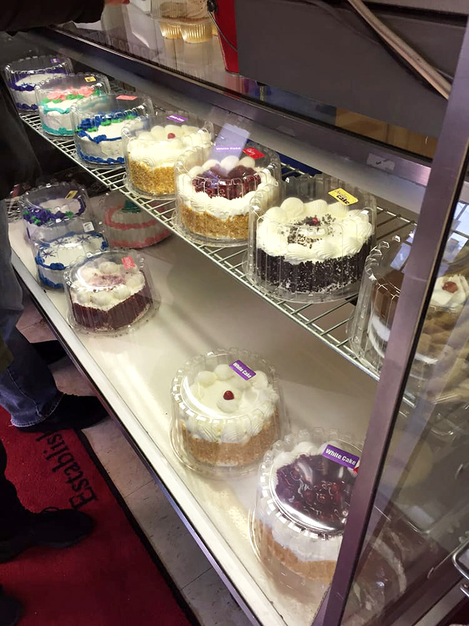 Layer cakes standing proud behind glass, like celebrities at their own premiere. Each one promises a different path to dessert nirvana.