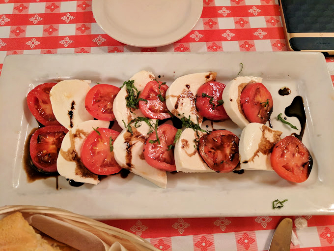 Caprese salad arranged like edible dominoes &ndash; when tomatoes and mozzarella play nice, everybody wins the game.