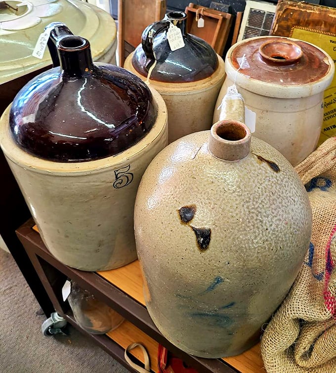 These stoneware jugs once held everything from whiskey to maple syrup, their sturdy forms a testament to practical beauty in everyday objects.