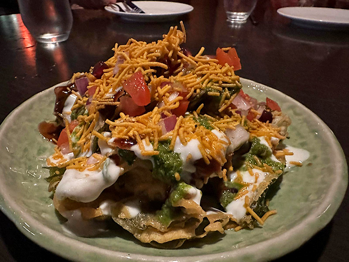 This chaat masterpiece wears its crunchy sev topping like a crown, yogurt drizzles creating rivers of coolness through the spiced landscape below.